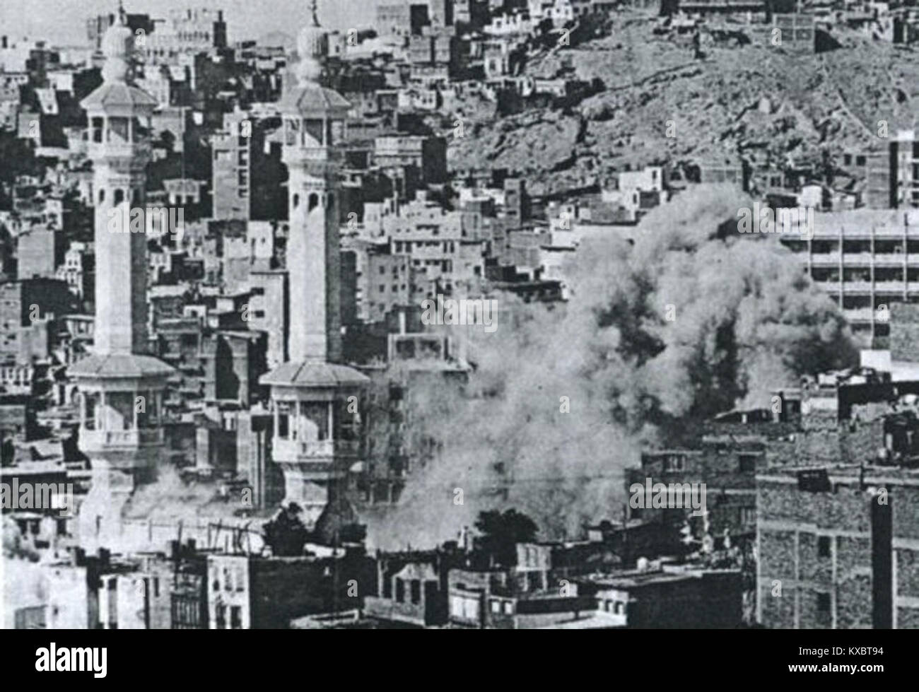 A photograph showing smoke rising from the Grand Mosque in Mecca during ...