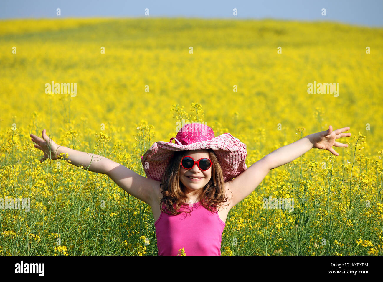 happy little girl with hands up on field spring season Stock Photo - Alamy