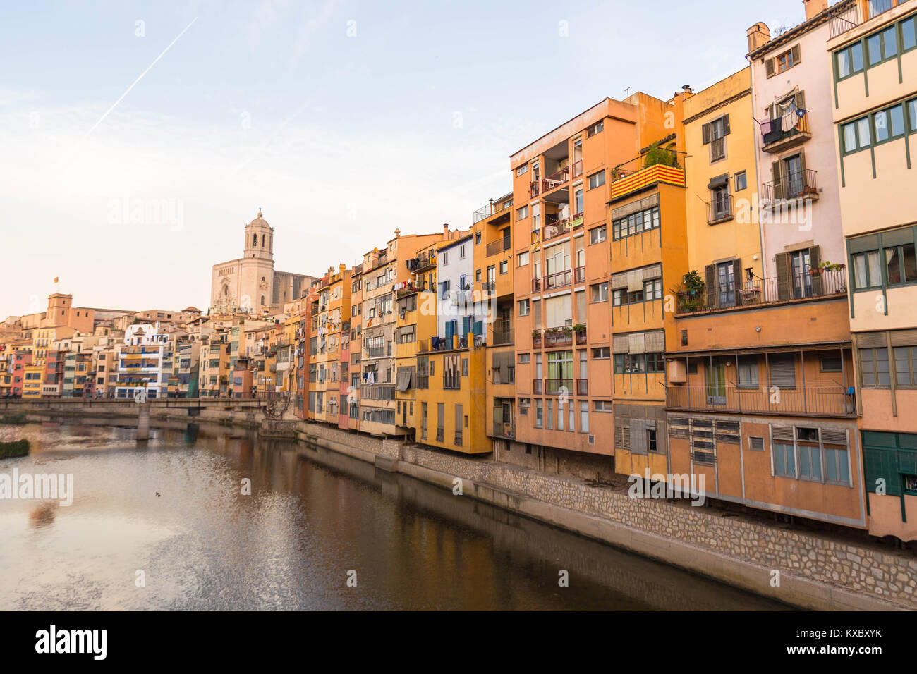 Onyar river crossing the downtown of Girona with bell tower of Basilica ...