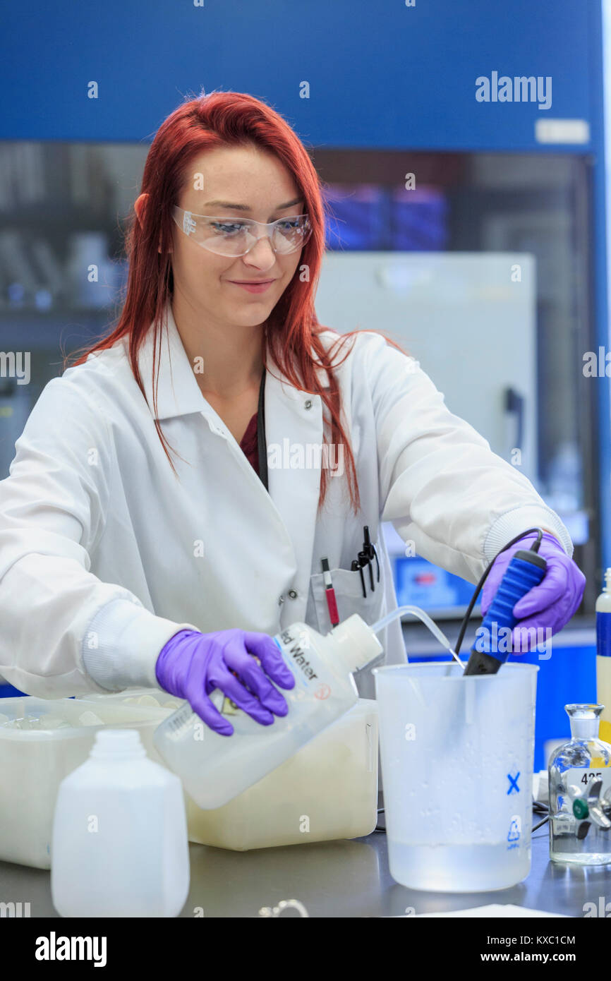 Lab chemist adding distilled water while measuring pH Stock Photo - Alamy