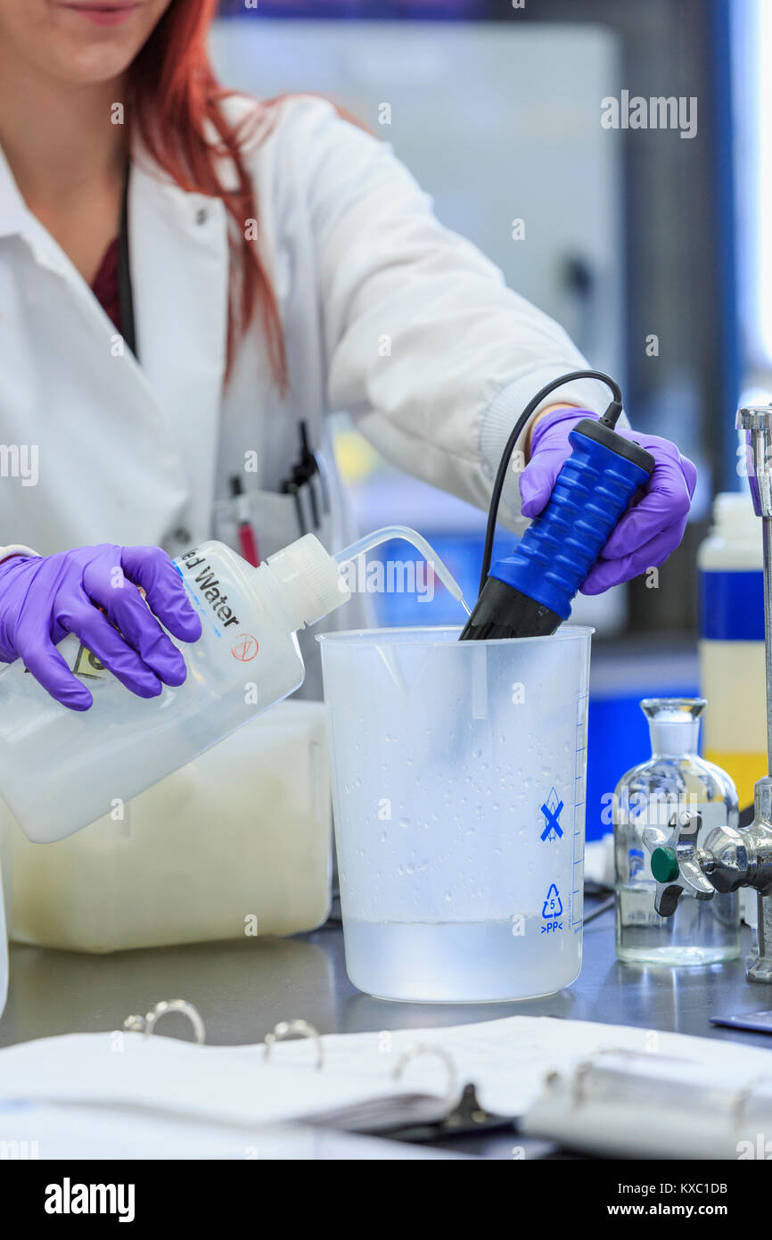 Lab chemist adding distilled water while measuring pH Stock Photo - Alamy