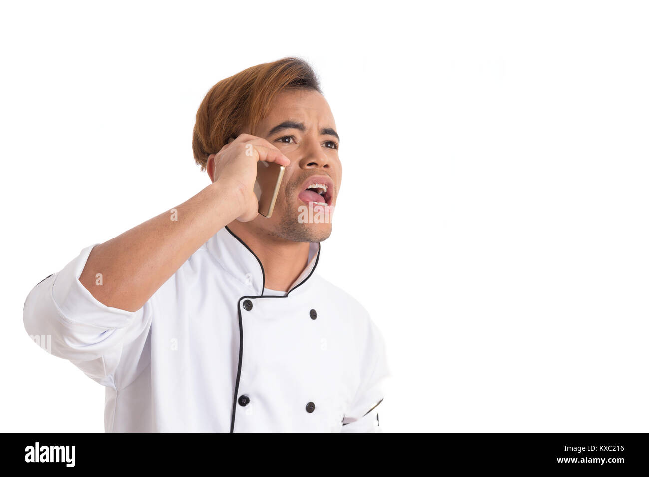 Angry man is screaming and holds a cell phone. Young chef is in uniform ...