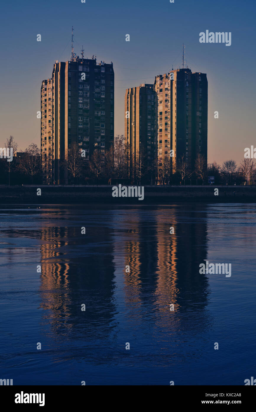 two buildings, reflection in water in sunset Stock Photo - Alamy