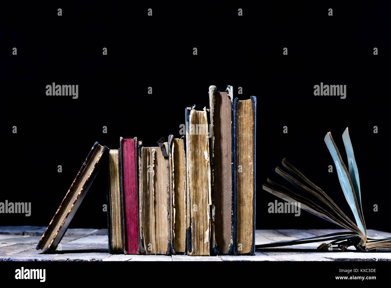 Old destroyed books on a wooden table. Reading room library with very ...