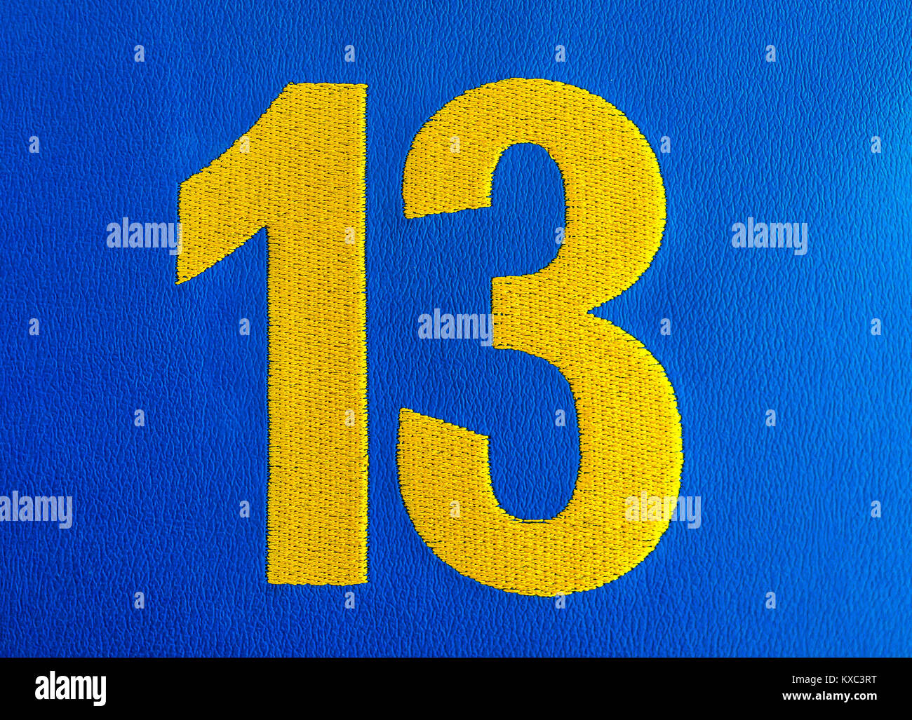 Closeup of woven thirteen 13 number on cloth against bright vibrant ...