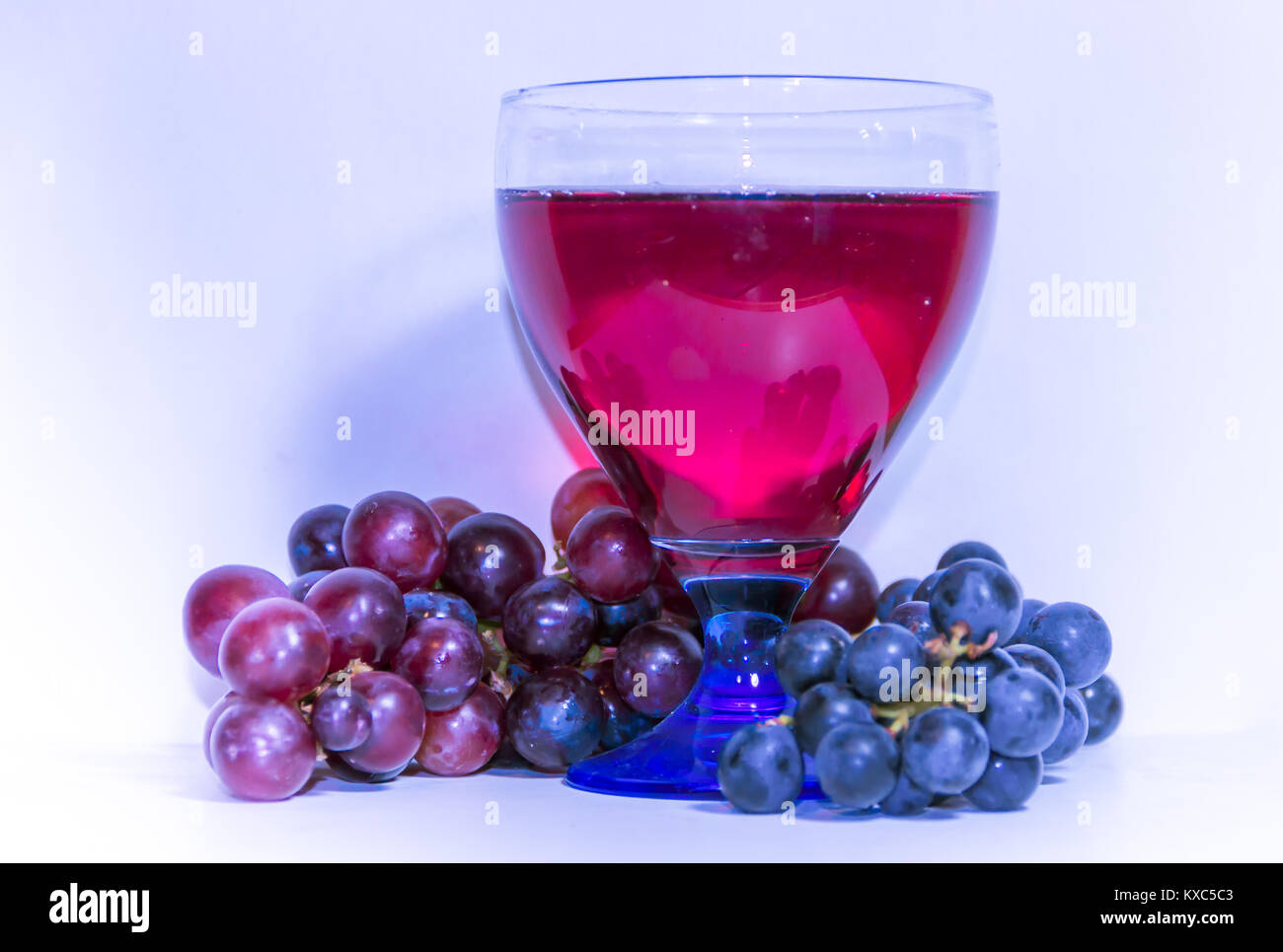 glass of wine and grapes in ultraviolet the color of the year Stock ...