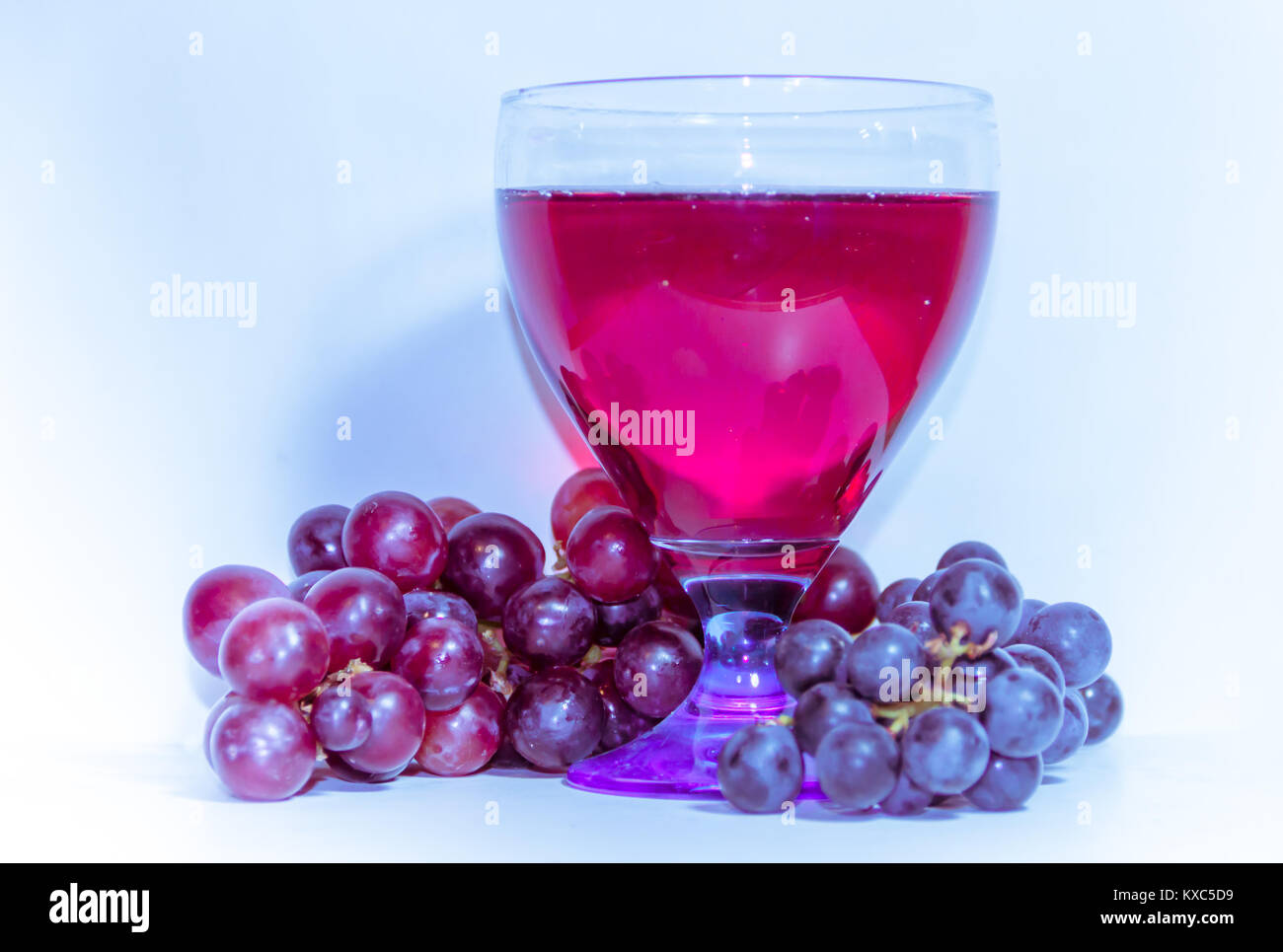 glass of wine and grapes in ultraviolet the color of the year Stock ...