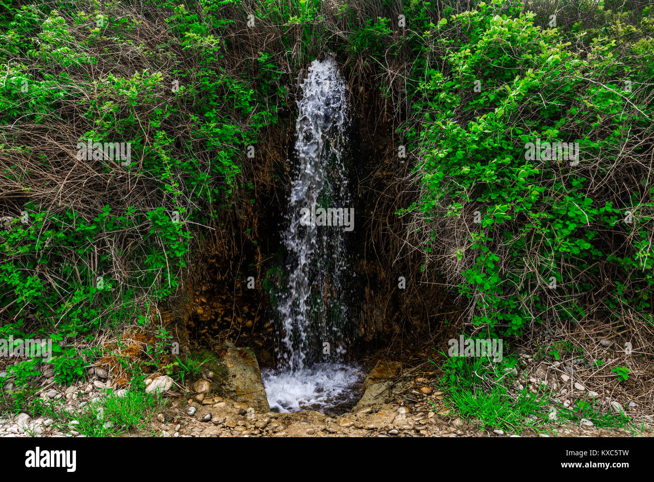 Small waterfall, holy spring Stock Photo - Alamy