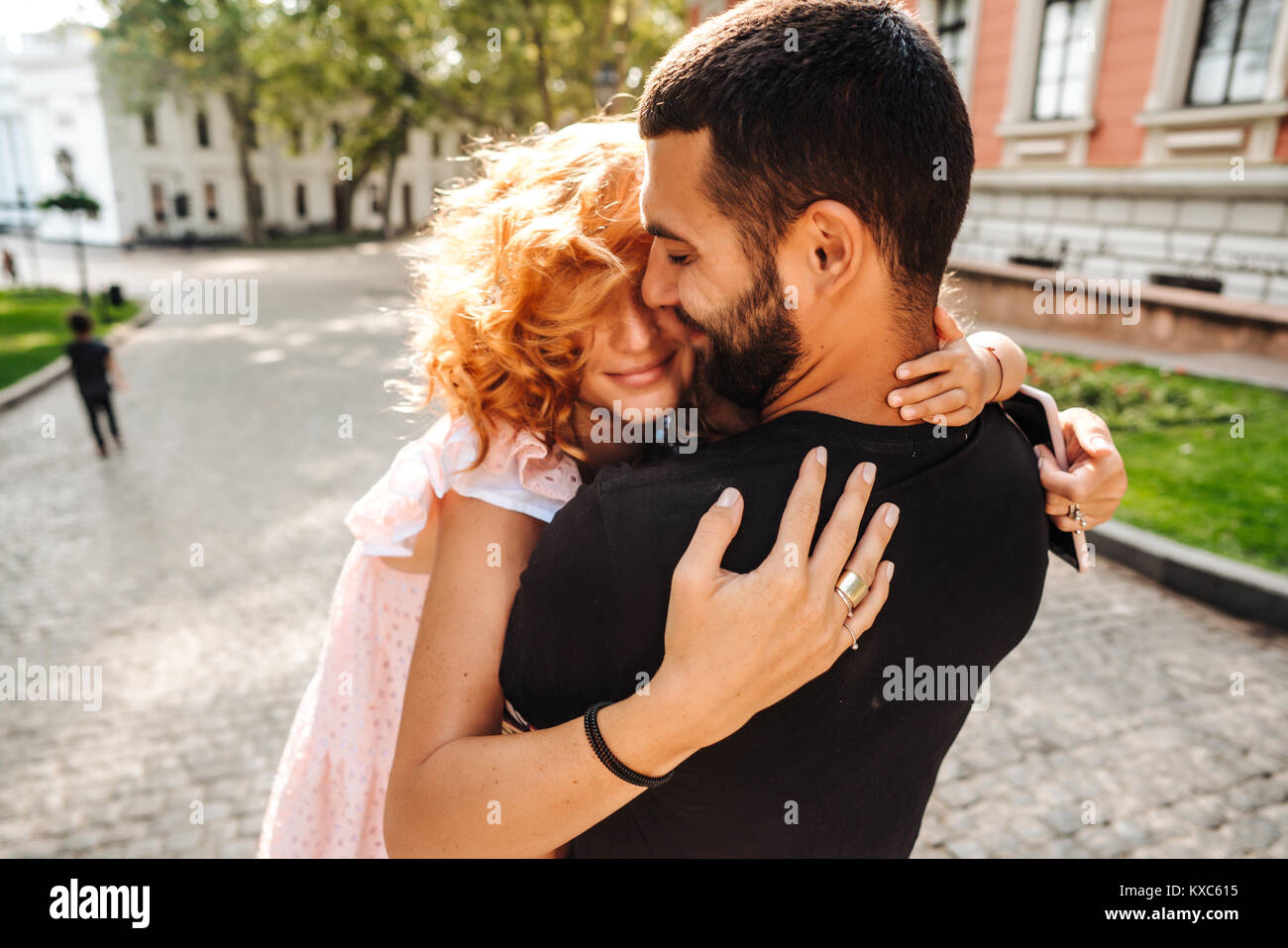 Cute couple hugging on the street Stock Photo - Alamy