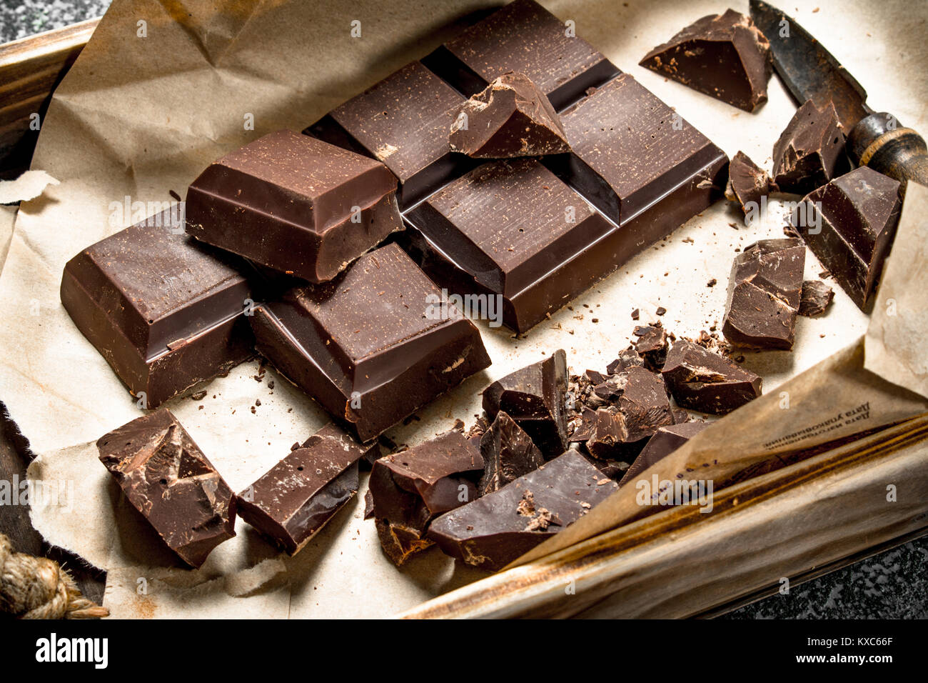 Dark chocolate on old paper. Top view Stock Photo - Alamy