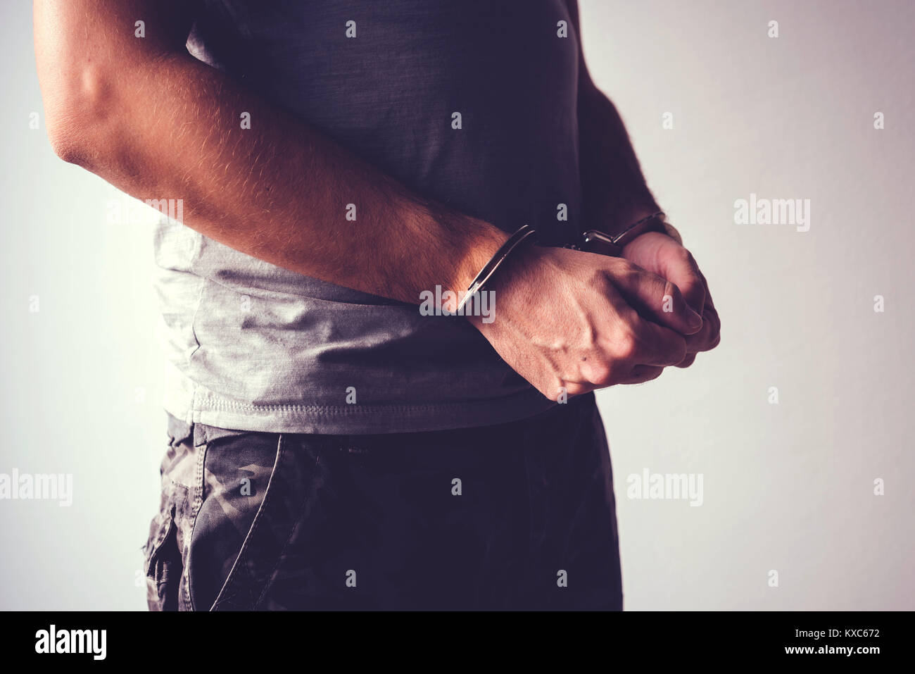 Handcuffed soldier in military army clothes. Prisoner of war or ...