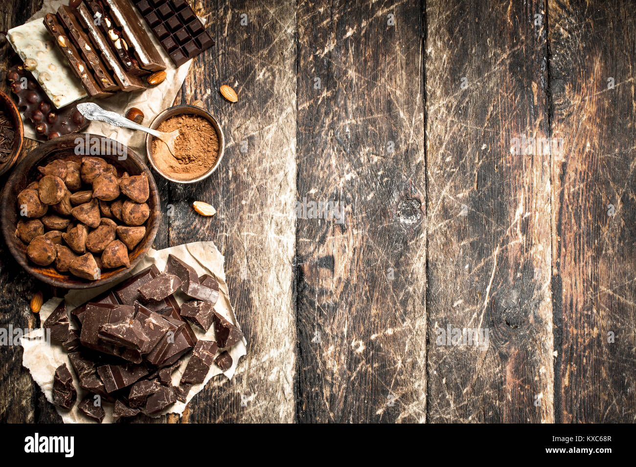 Different types of chocolate, cocoa powder and pieces of dark chocolate ...