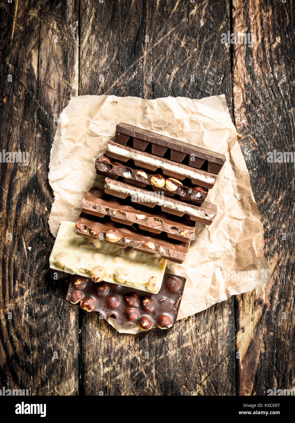 Different chocolate bars. On a wooden background Stock Photo - Alamy