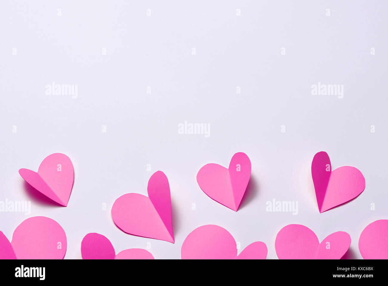 Beautiful pink paper hearts on white paper background Stock Photo - Alamy