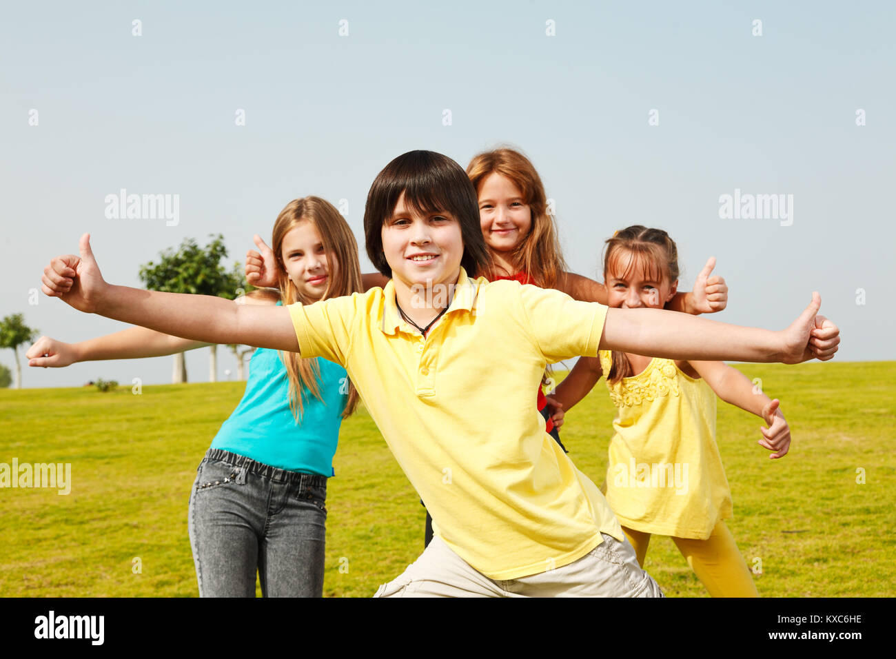 Group of four happy children showing thumbs up outdoors Stock Photo - Alamy Group of four happy children showing thumbs up outdoors Stock Photo - Alamy
