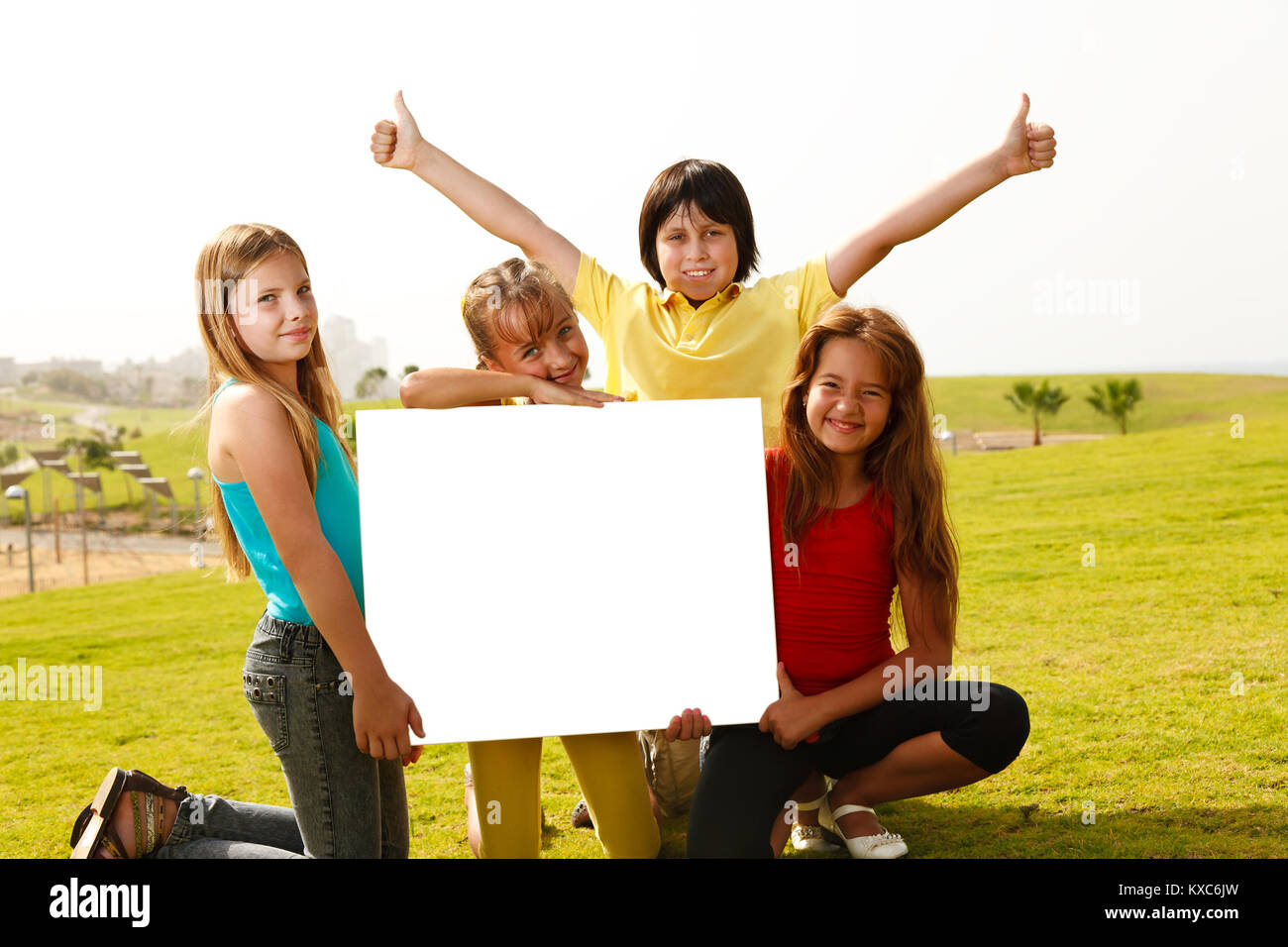 Group of people holding a big white board for advertisements Stock ...