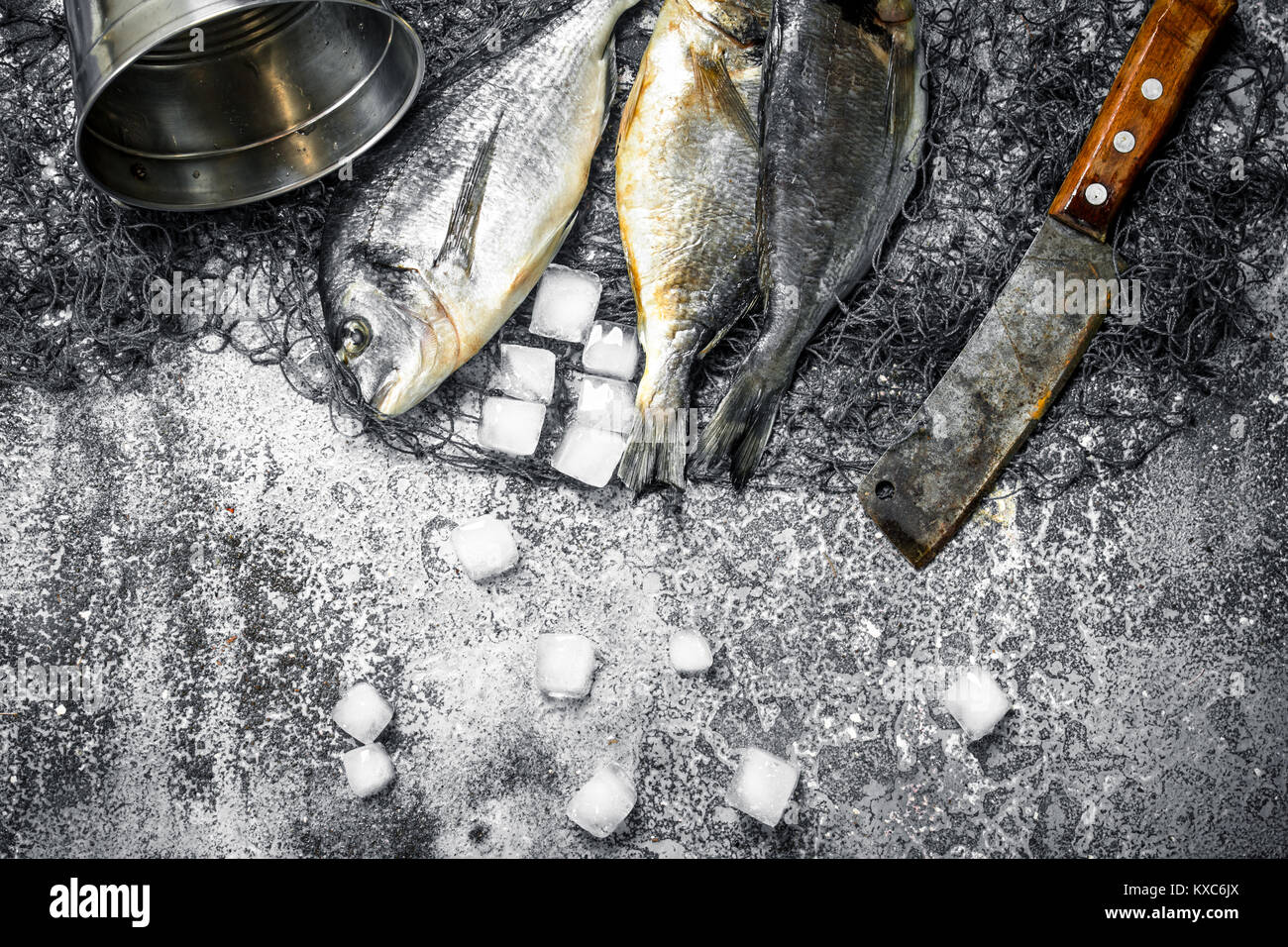 Fresh unprepared dorado fish on a cutting board. On a rustic background ...