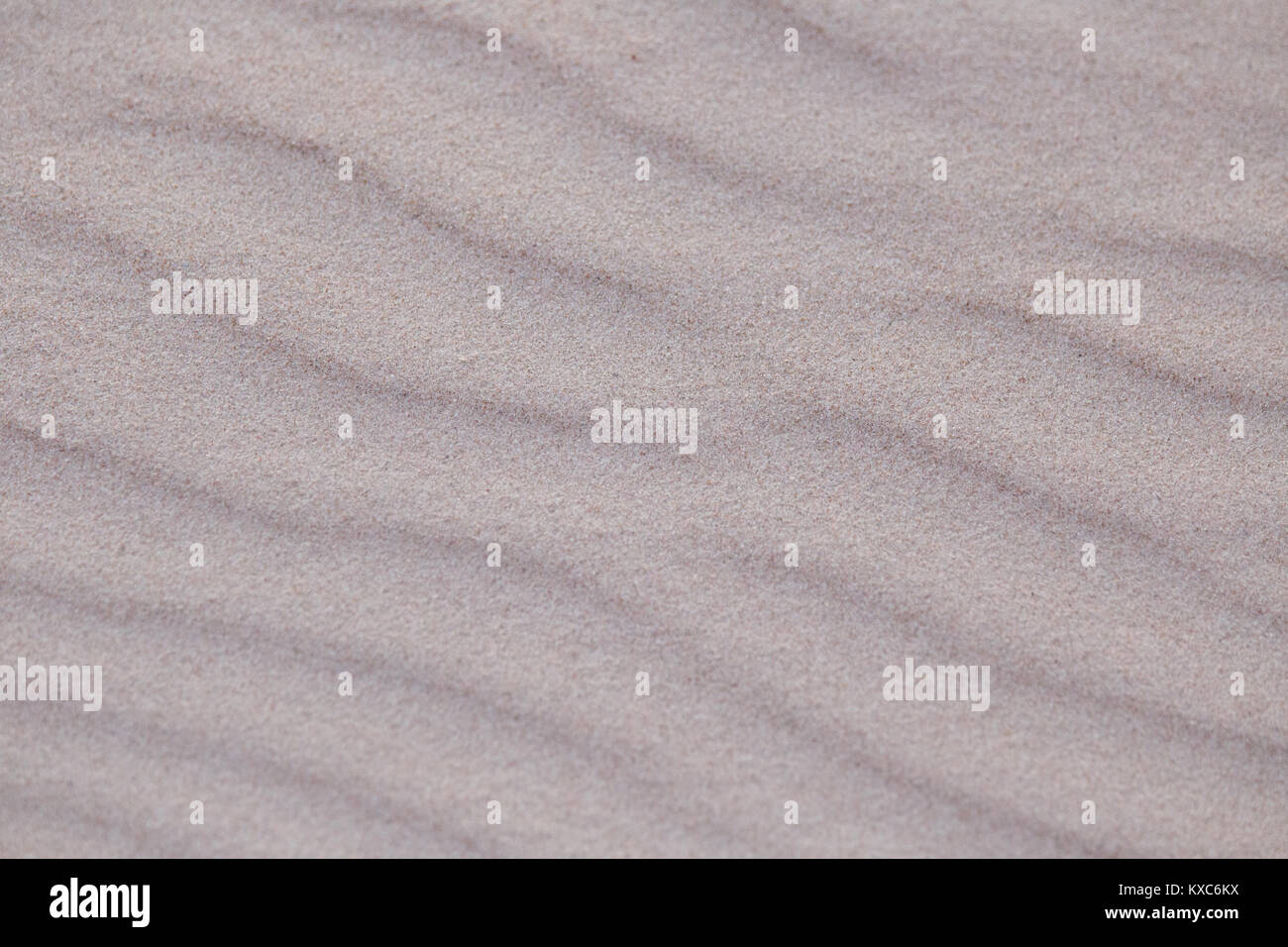 A beautiful pattern of white sand on a beach of Baltic Sea. Closeup ...