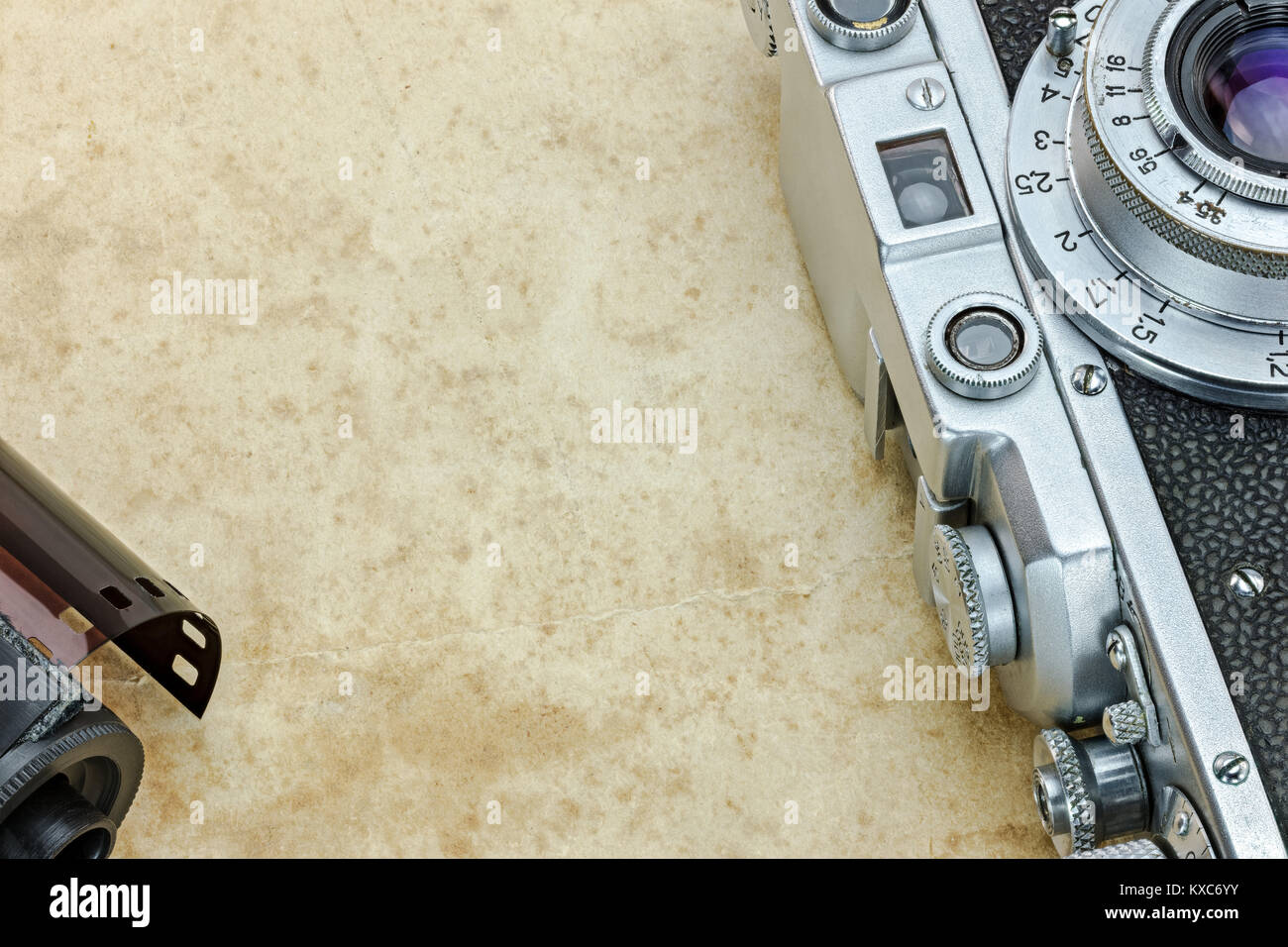 retro camera in details and negative film on brown paper background ...