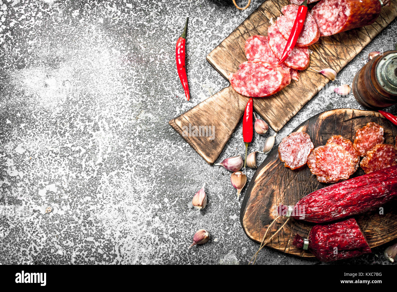 Salami background. Different kinds of salami with spices. On a rustic ...