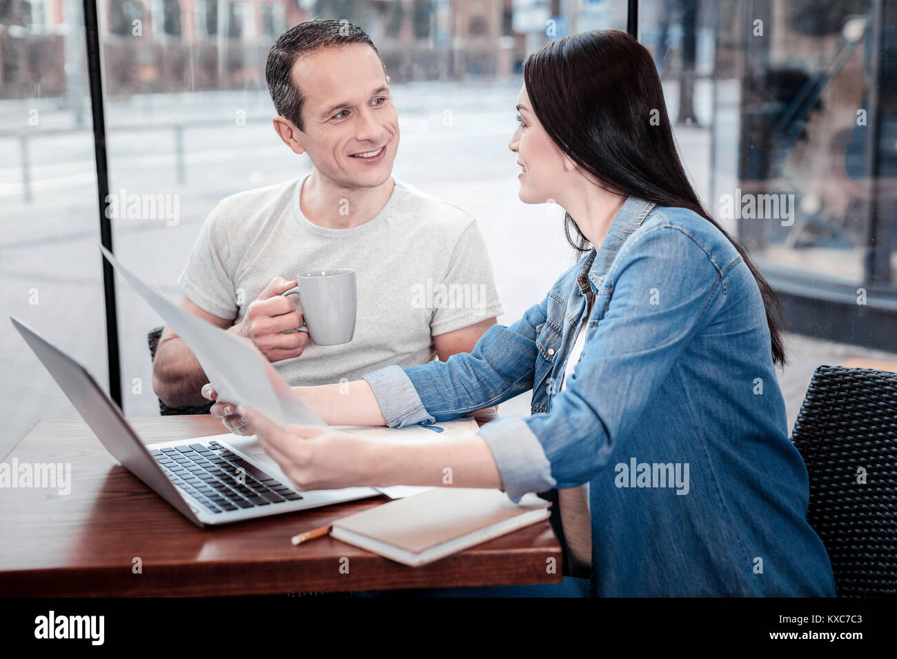 Pretty girl talking with her colleague Stock Photo - Alamy