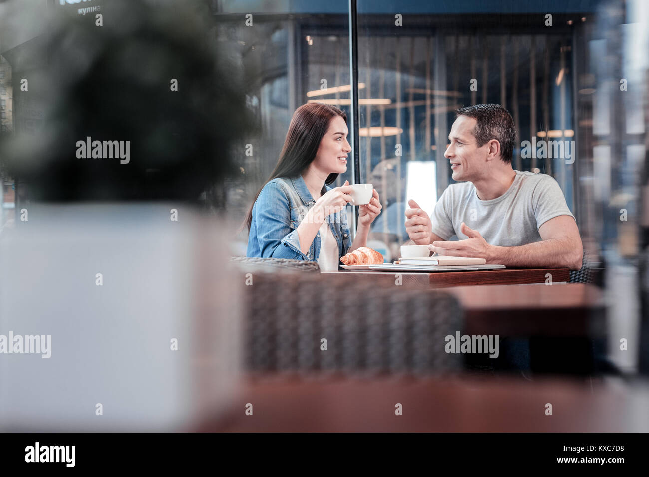 Friendly partners discussing their project Stock Photo - Alamy
