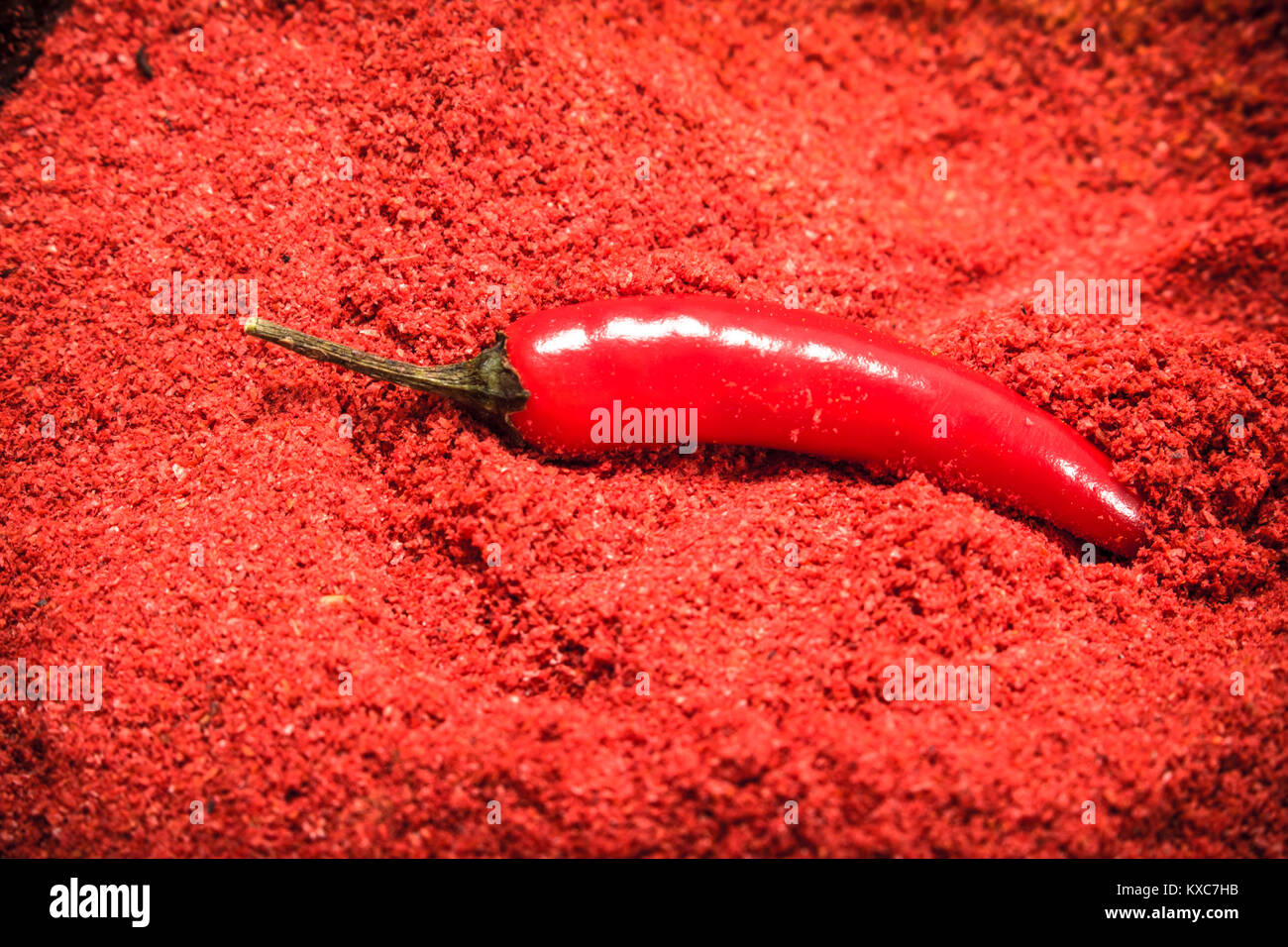 Ground red pepper . On a rustic background Stock Photo - Alamy