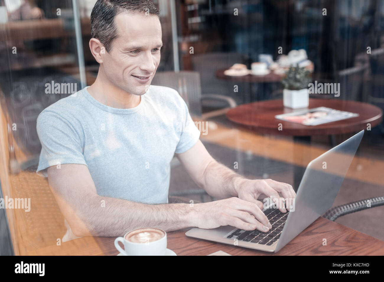 Handsome male person using his computer Stock Photo - Alamy