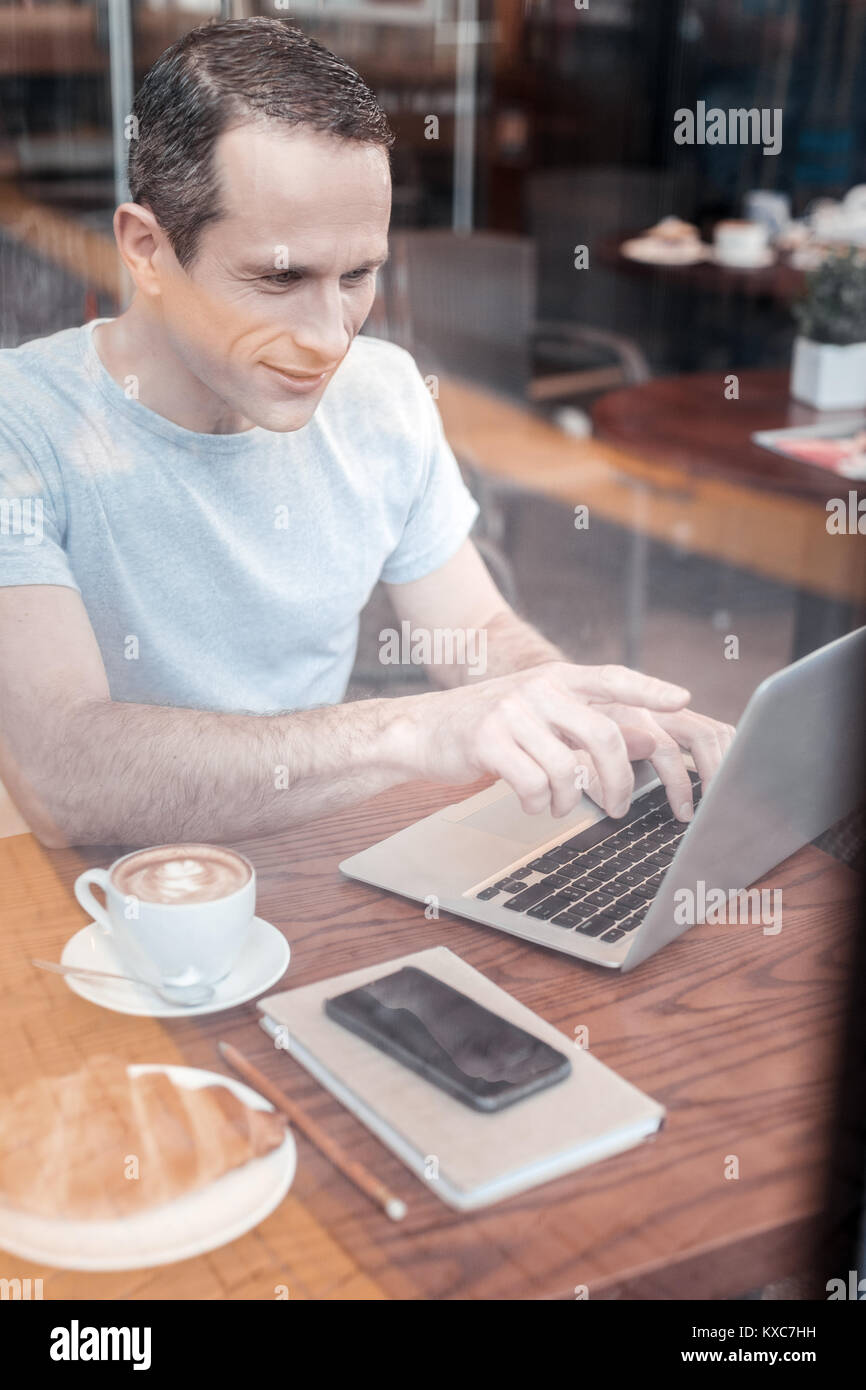 Serious man pointing at his laptop Stock Photo - Alamy