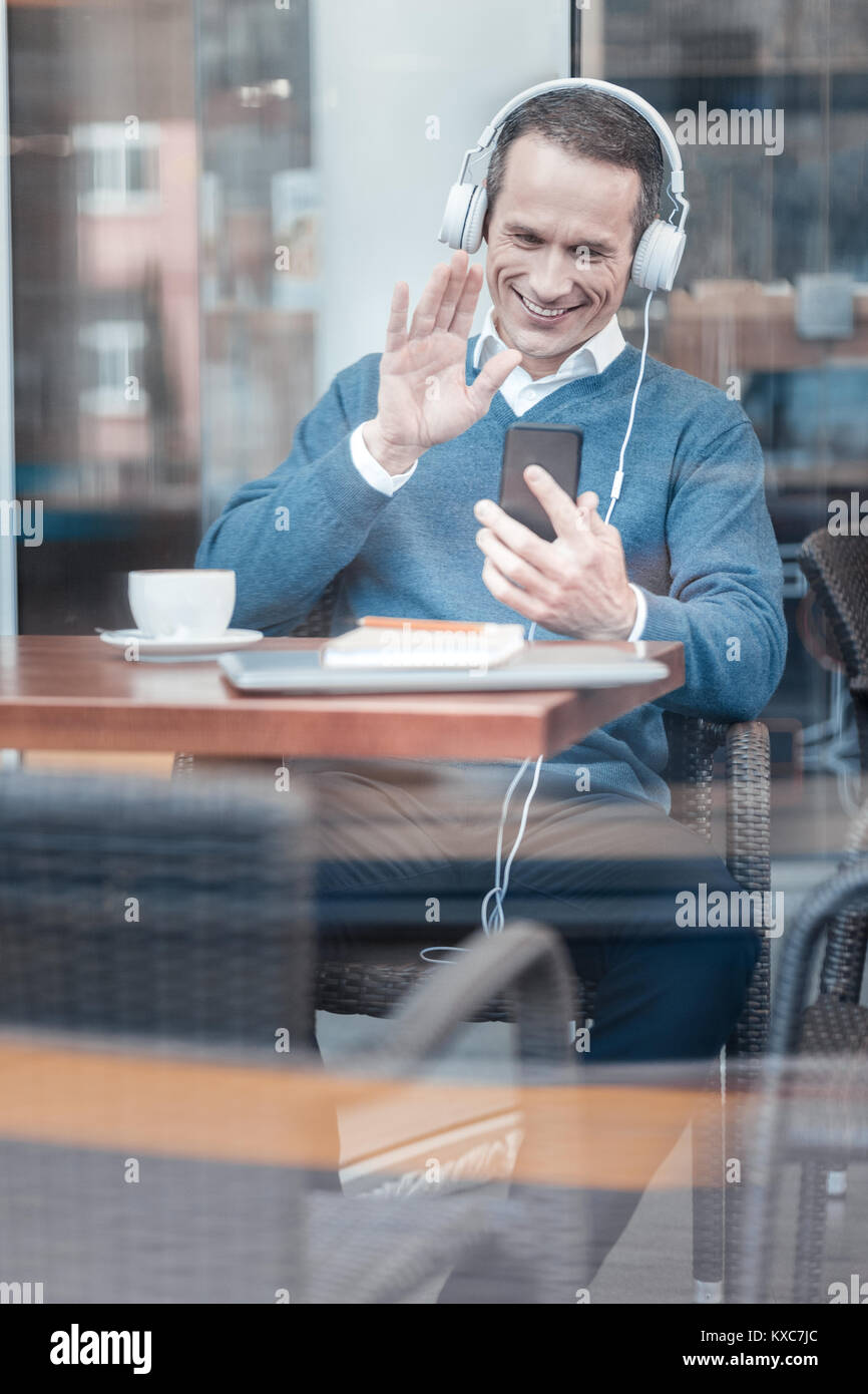 Attractive man having video conversation Stock Photo - Alamy