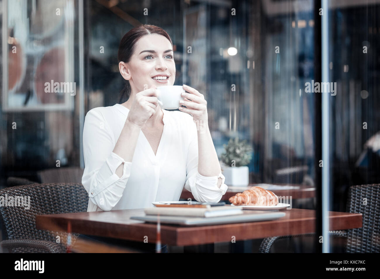 Relaxed female person drinking tea Stock Photo - Alamy