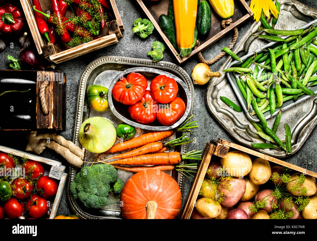 Organic food. Fresh crop of vegetables in boxes. On a rustic background ...