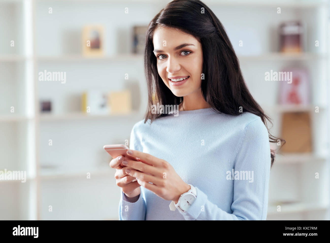 Gorgeous brunette woman checking messages Stock Photo - Alamy
