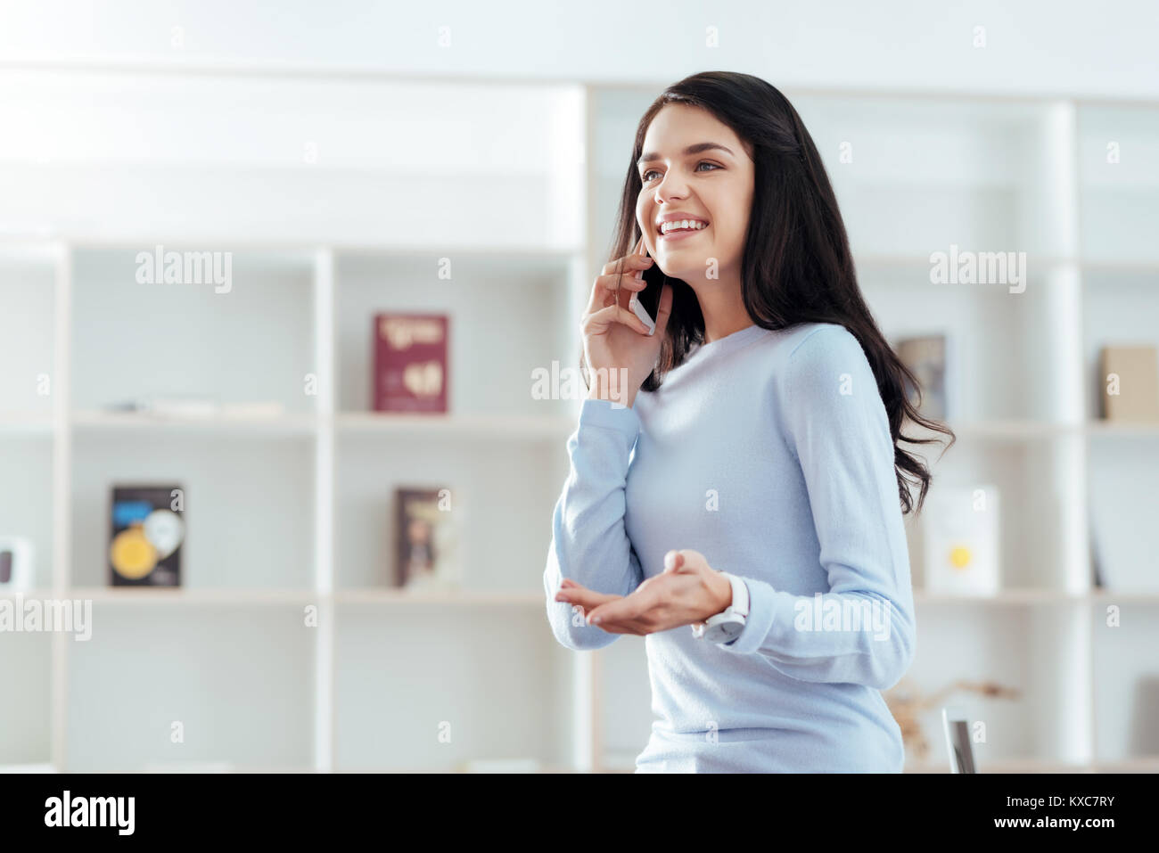 Cheerful cute woman answering call Stock Photo - Alamy