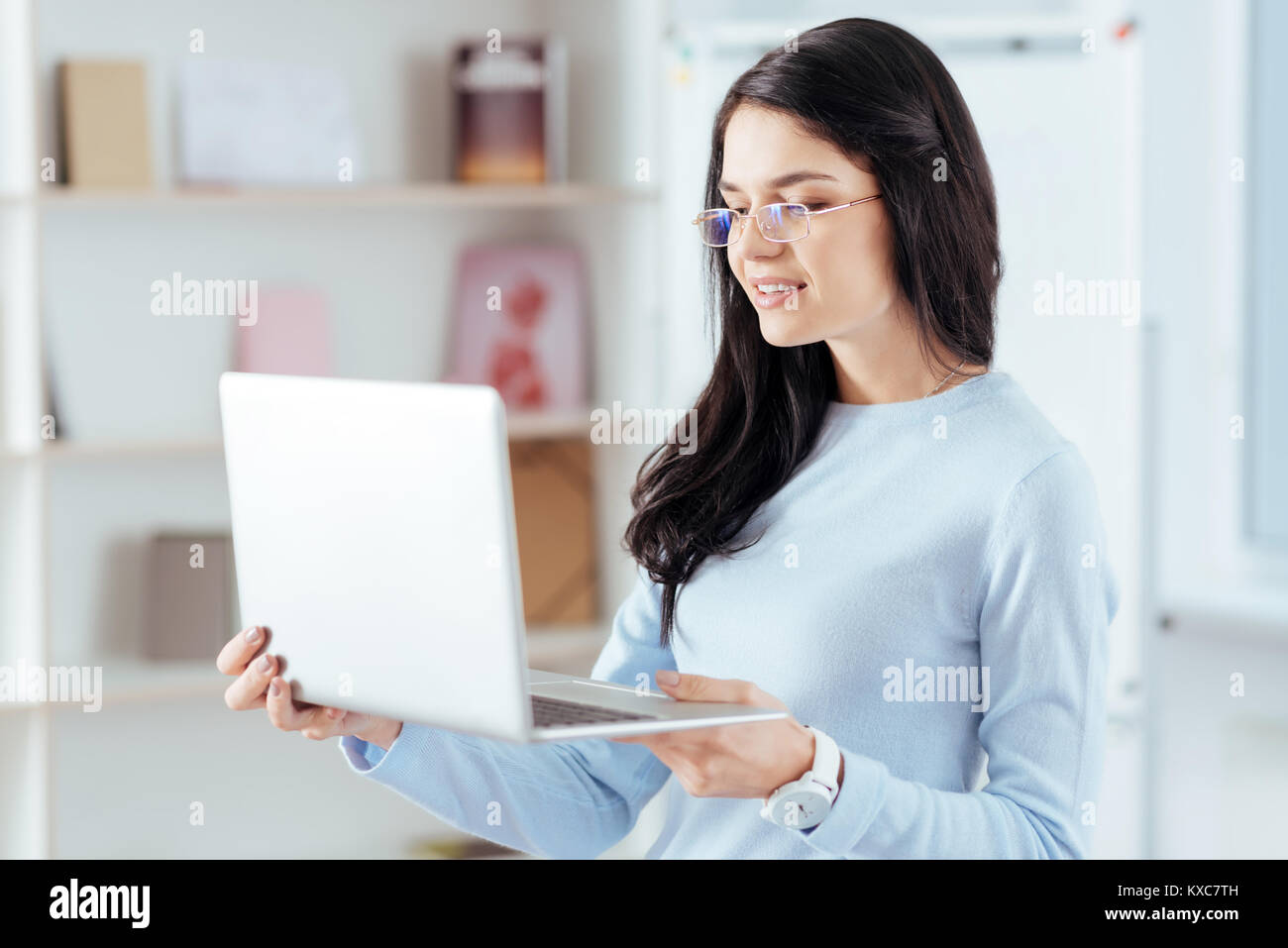 Happy glad woman watching presentation Stock Photo - Alamy