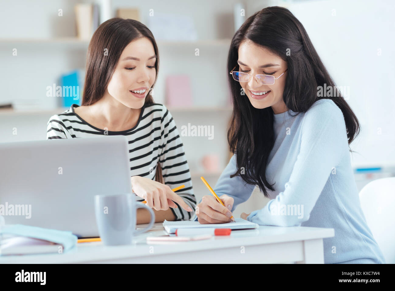 Beautiful female colleagues working hard Stock Photo - Alamy