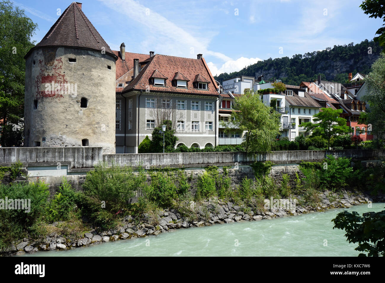 FELDKIRCH, AUSTRIA - CIRCA JULY 2016 Tower and house on the bank of ...