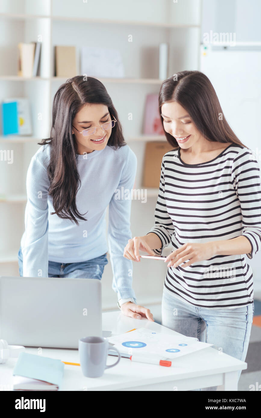 Appealing female colleagues shooting diagram Stock Photo - Alamy