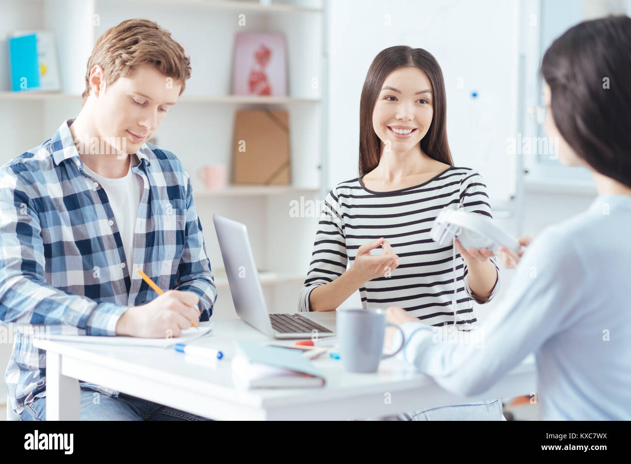 Diligent three students studying together Stock Photo - Alamy