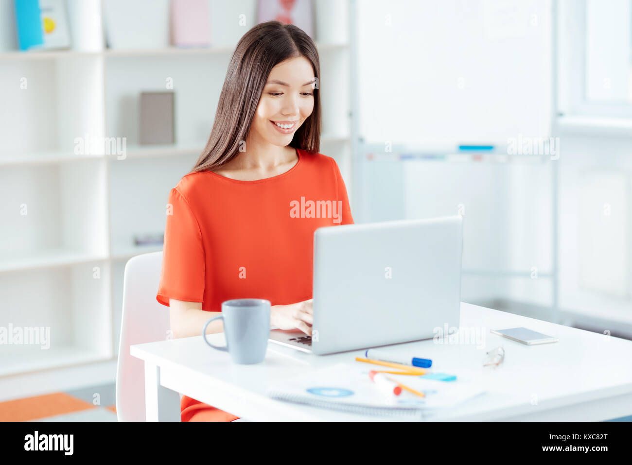Focused appealing woman typing email Stock Photo - Alamy