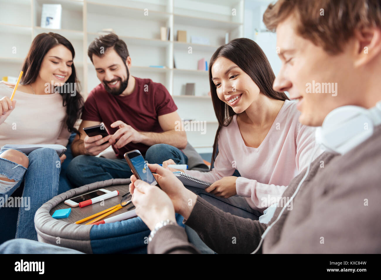 Joyful four friends hanging out together Stock Photo - Alamy