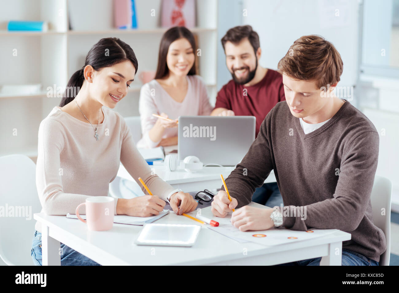Focused four colleagues preparing project Stock Photo - Alamy