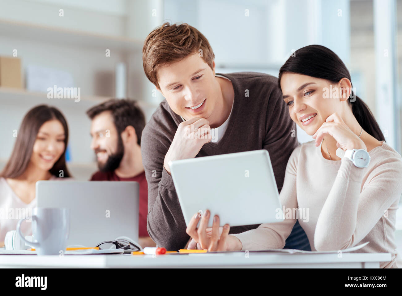 Happy two colleagues admiring their work Stock Photo - Alamy