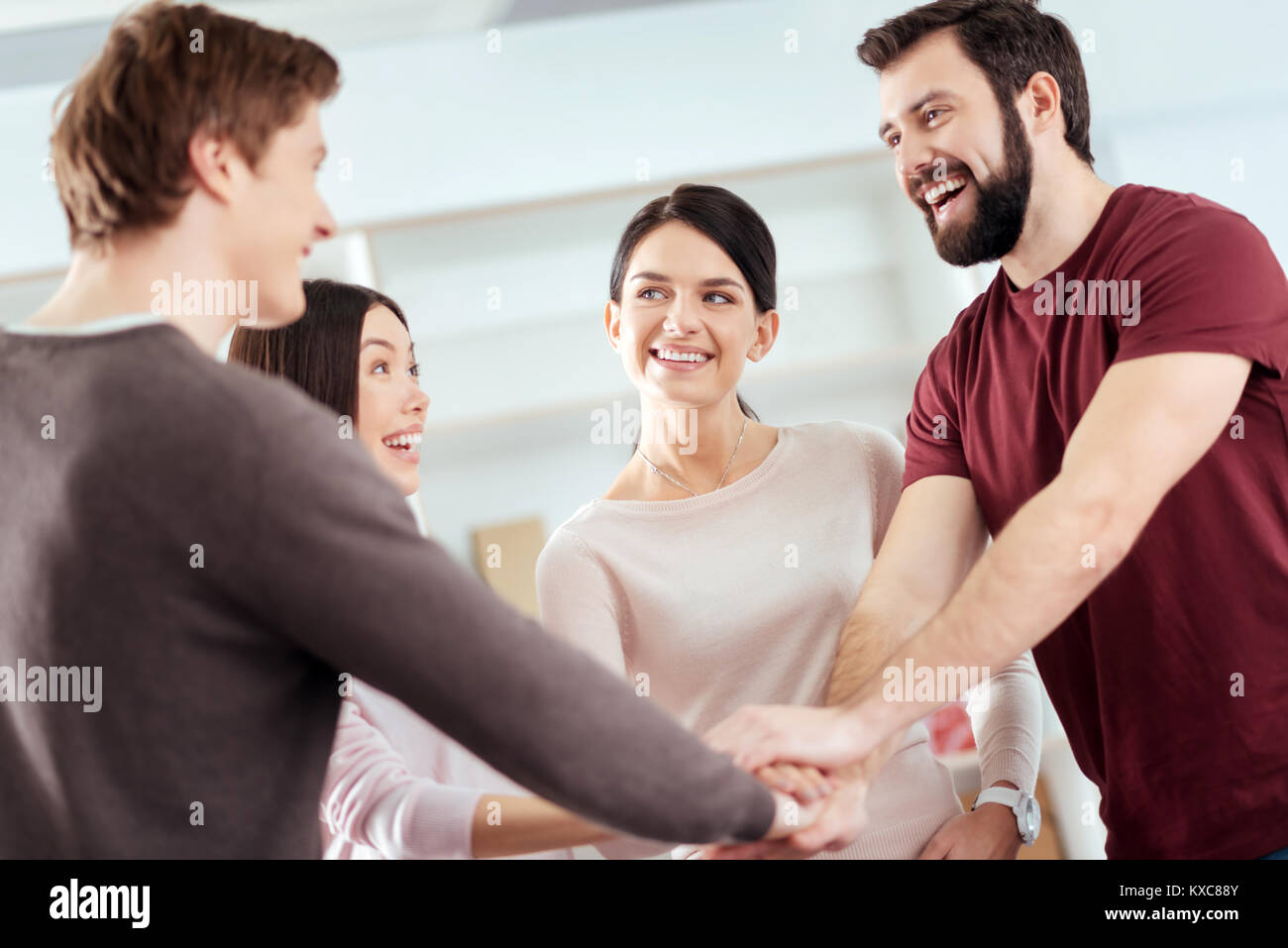 Charming four colleagues achieving results Stock Photo - Alamy