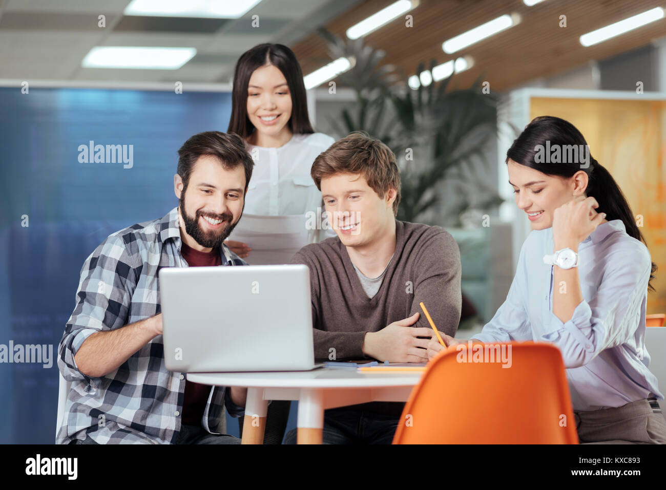 Skillful four colleagues planning strategy Stock Photo - Alamy