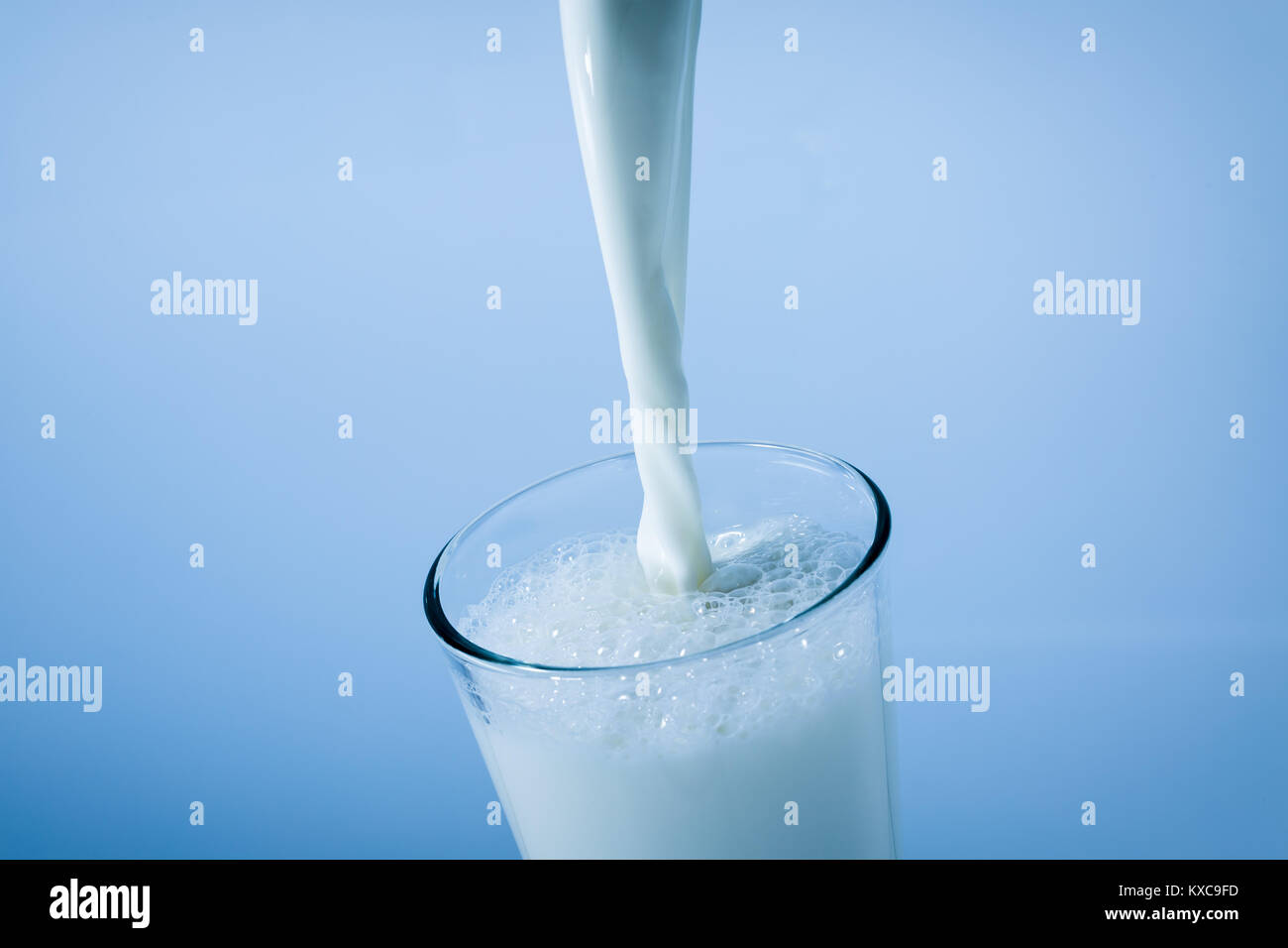 Pouring milk into a glasswith sparkling milk and bubbles, splash on ...