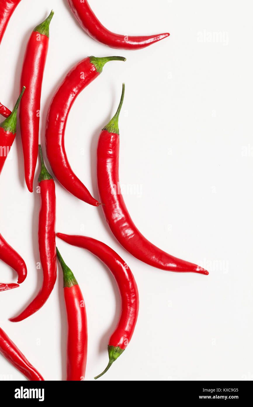 Red fresh chili peppers on a plain white background Stock Photo - Alamy