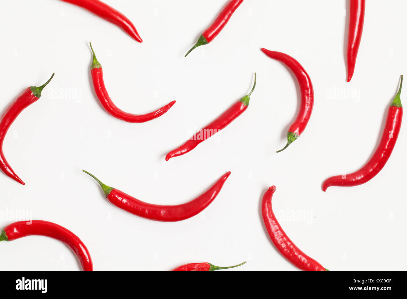Red fresh chili peppers on a plain white background Stock Photo - Alamy