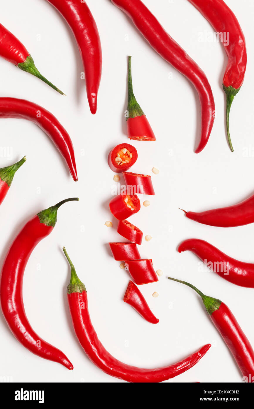 Sliced red chili pepper arranged on a plain background Stock Photo - Alamy