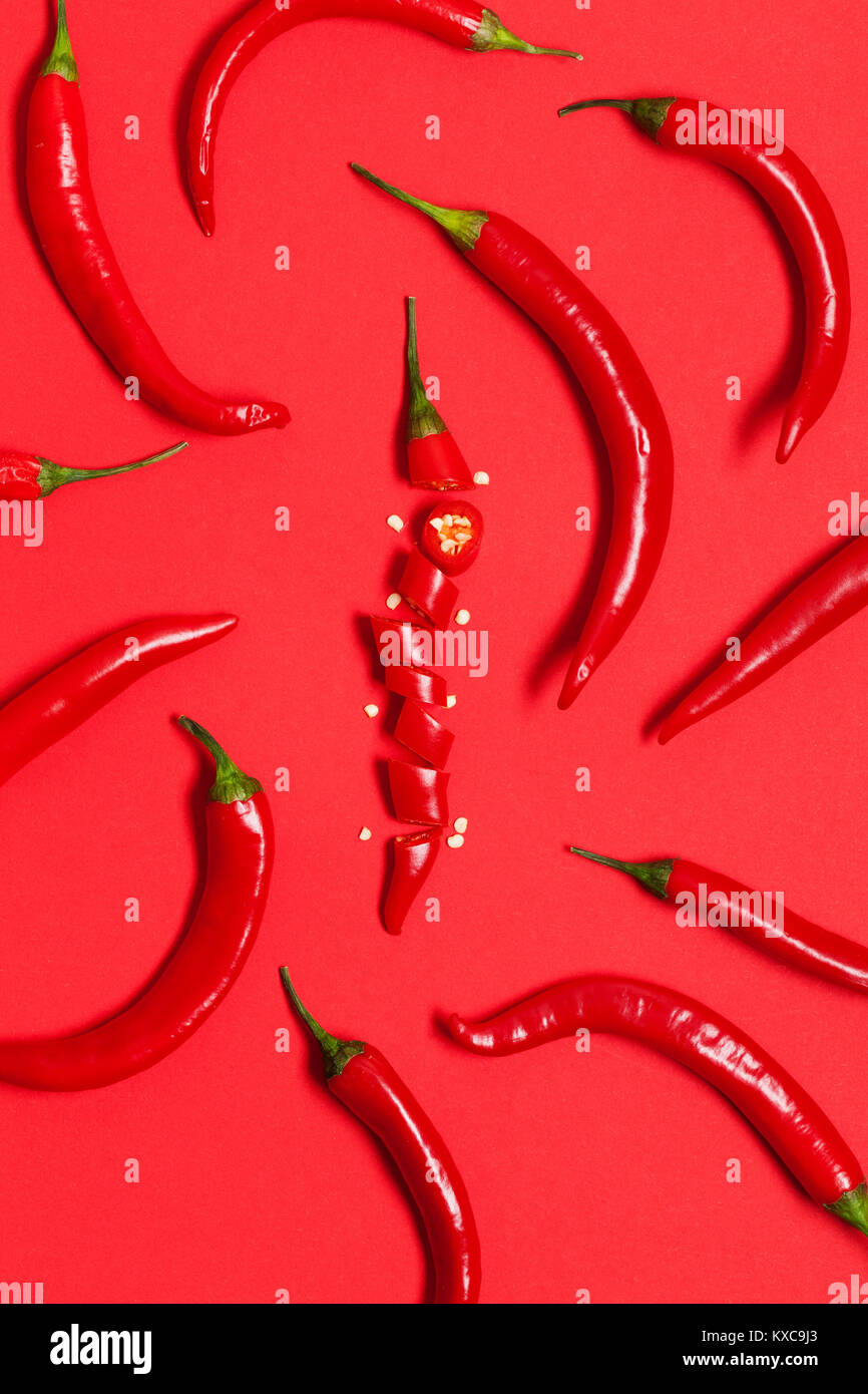 Sliced red chili pepper arranged on a bright red background Stock Photo ...